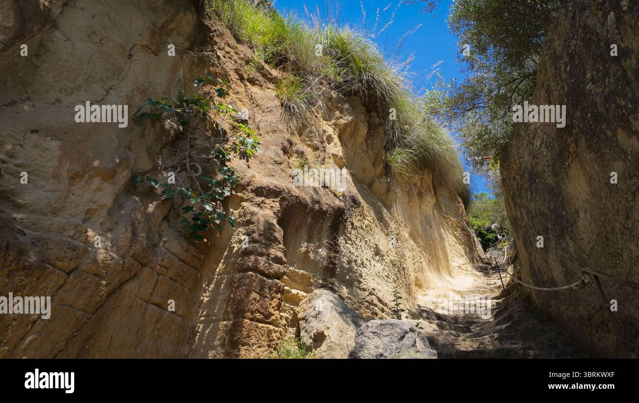 Narrow path leading through the rupestrian settlement of Zungri ...