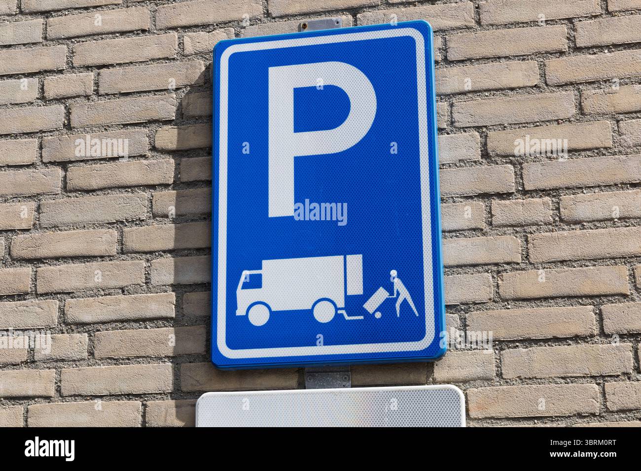 A blue parking sign specifically for delivery vans and loading ...