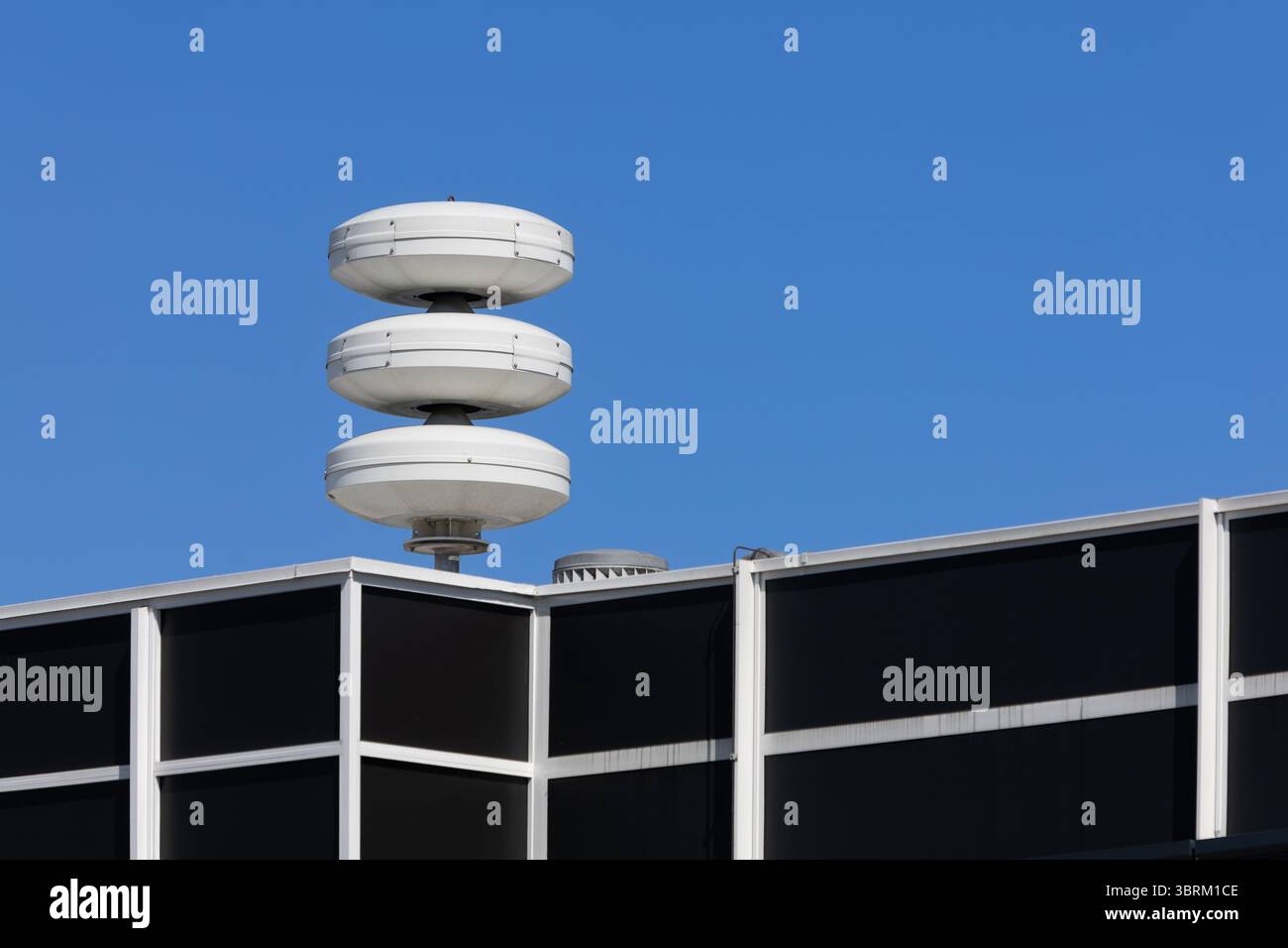 A large, multi-tiered civil defense siren or public address system ...
