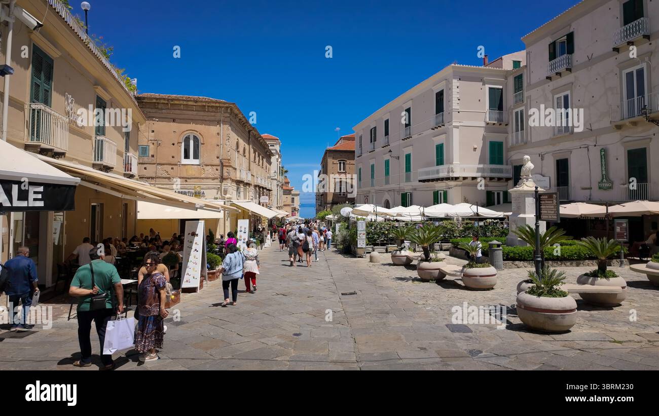 TROPEA, ITALY - JUNE 2, 2025 - Tourists walking down a street full of ...