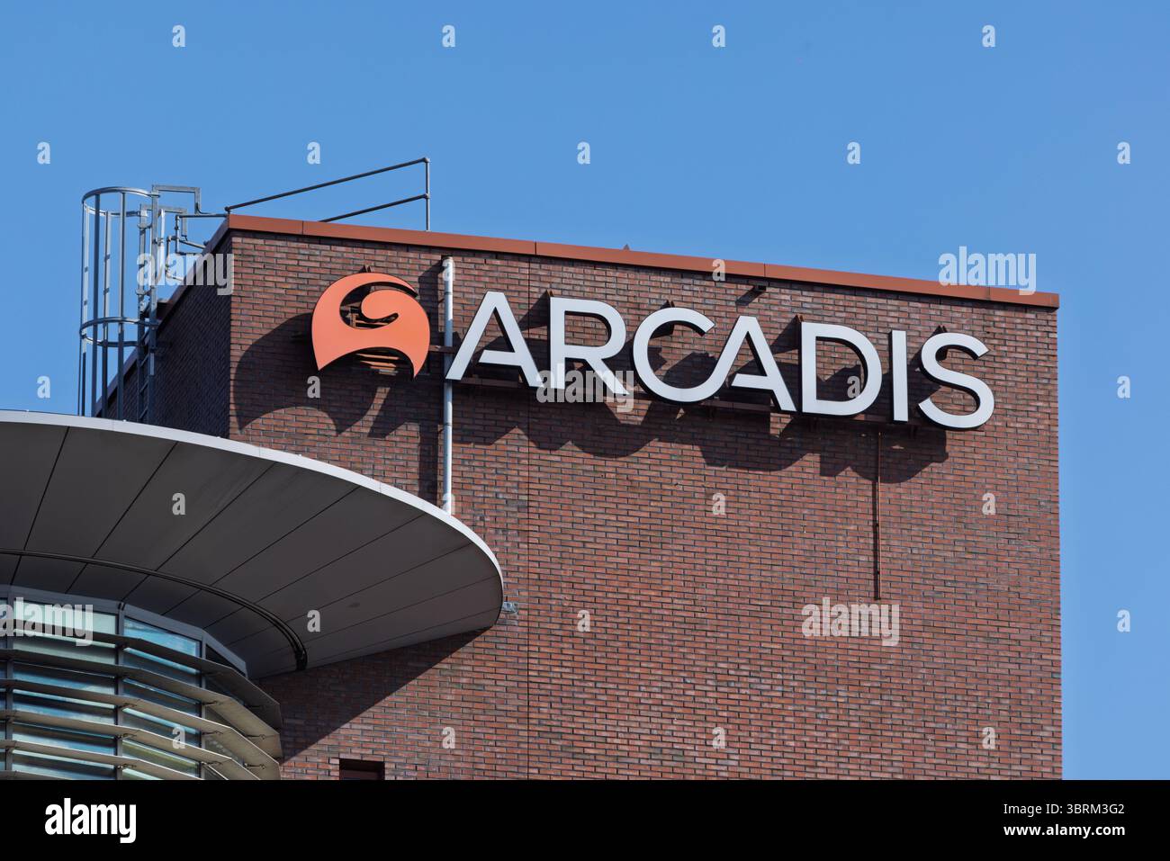 The Arcadis logo prominently displayed on a modern brick building, set ...