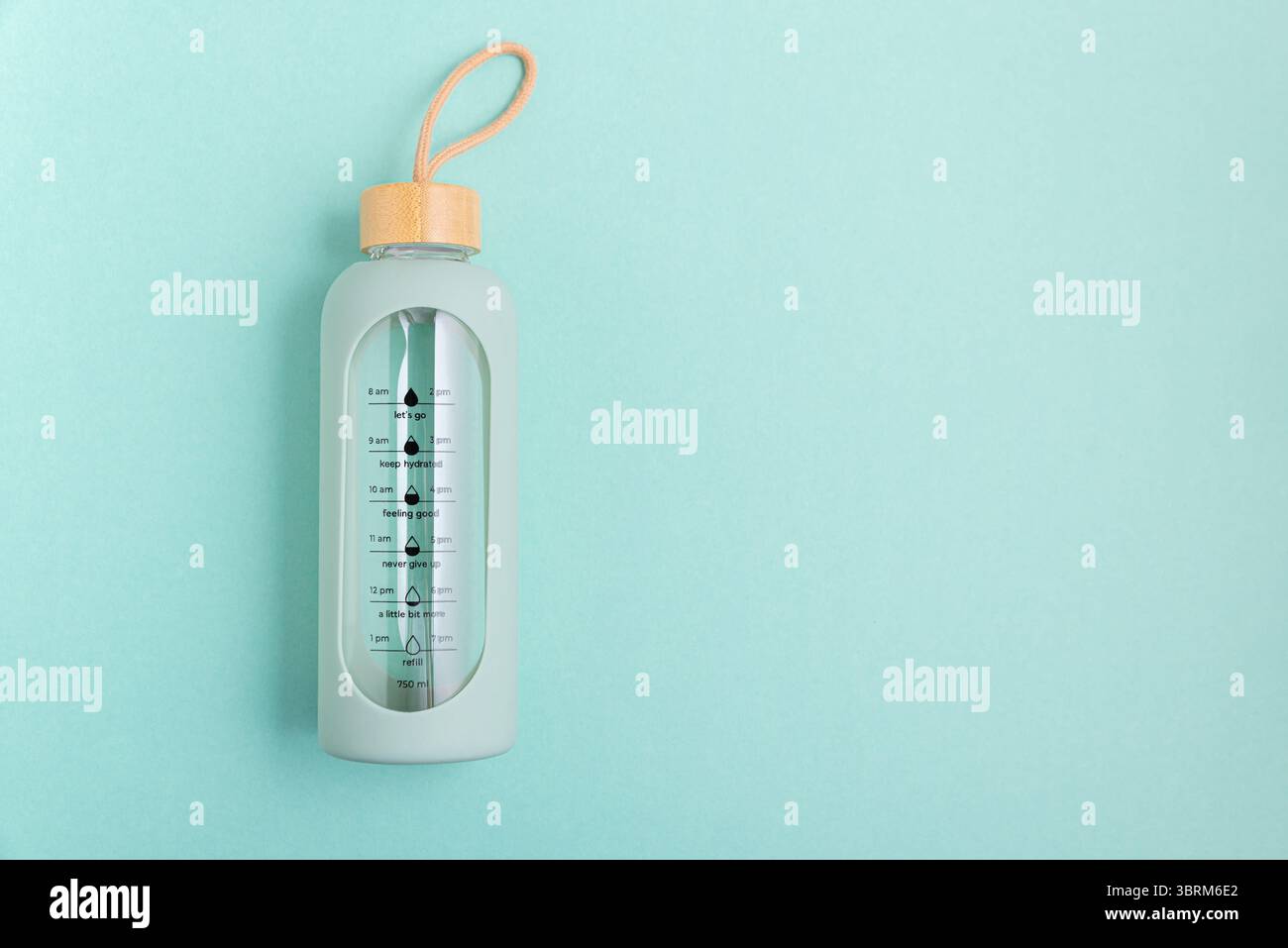 A glass water bottle with time markers on a blue background Stock Photo ...