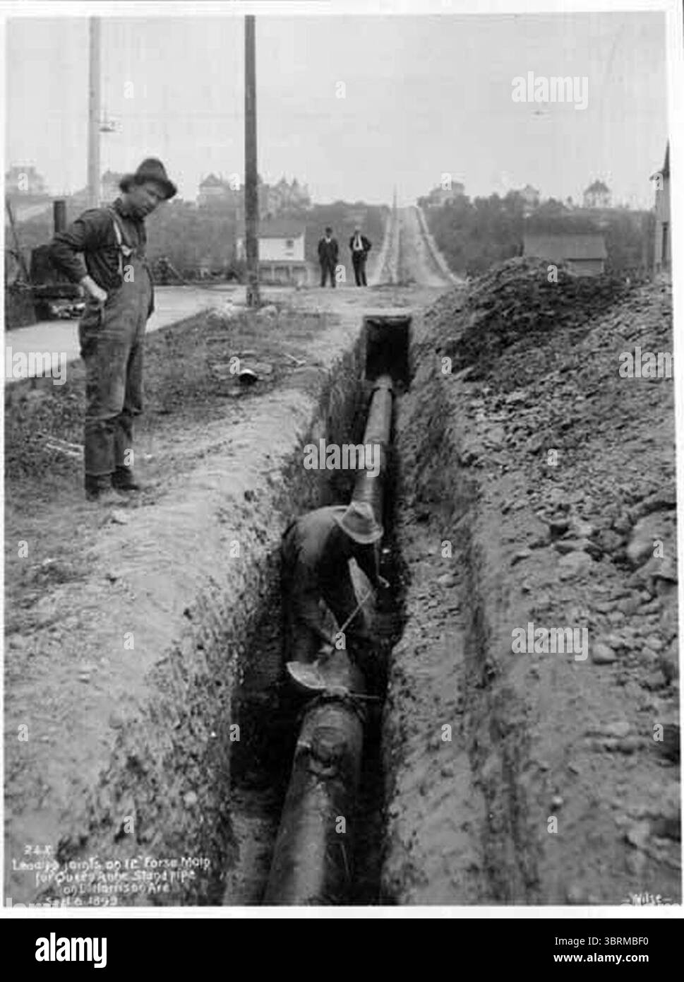 Man applying molten lead to main water pipeline joints near Queen Anne ...