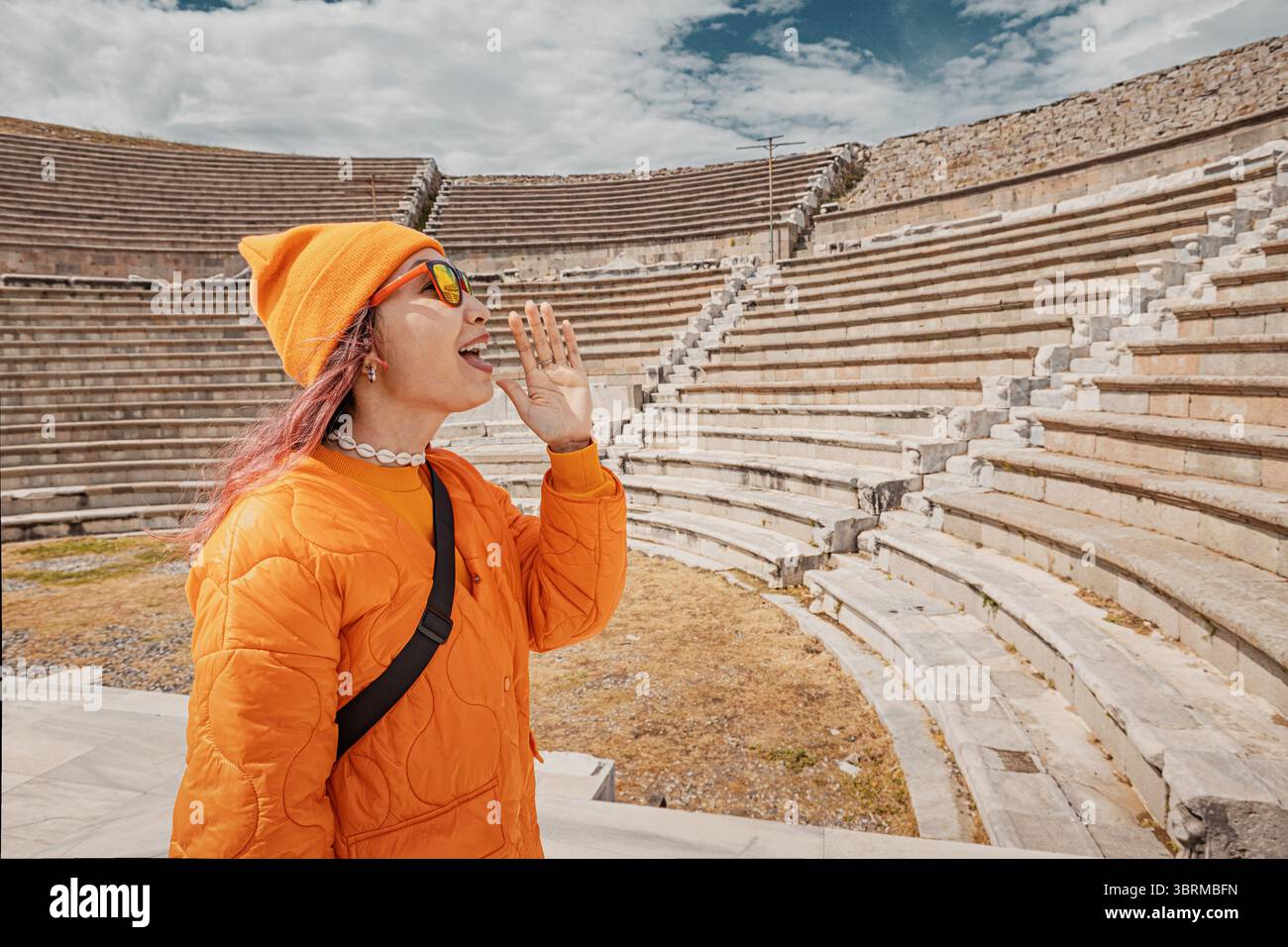 Girl testing echo and acoustics at ancient amphitheater, concept of ...