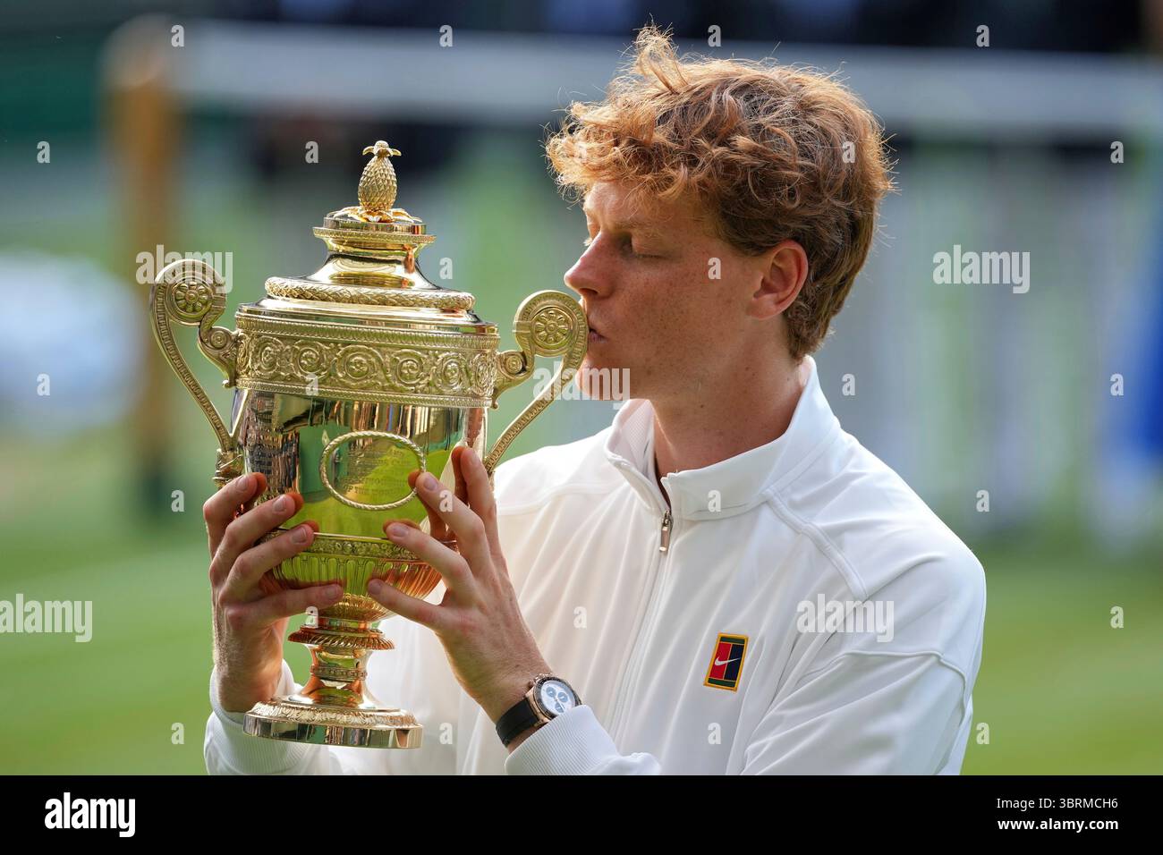 Italy's Jannik Sinner kisses the trophy after beating Carlos Alcaraz of ...