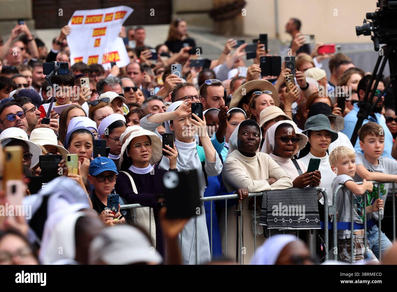 Nuns wait in the square as Pope Leo XIV celebrates Sunday Mass at the ...