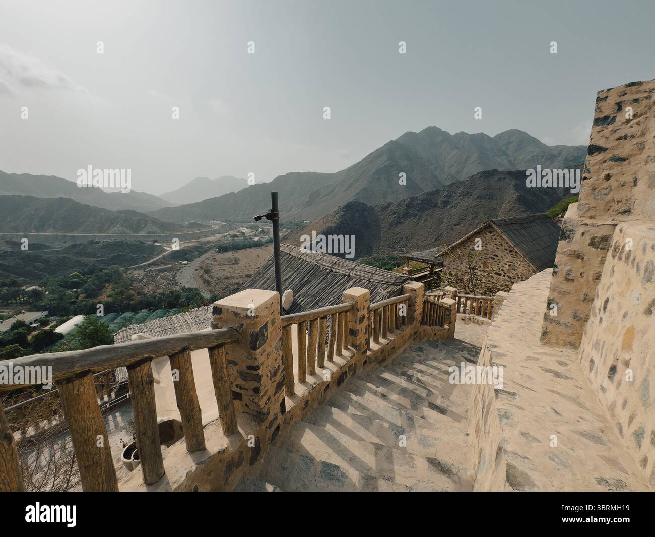 a pathway leading to a house in the mountains, rustic stone walls ...