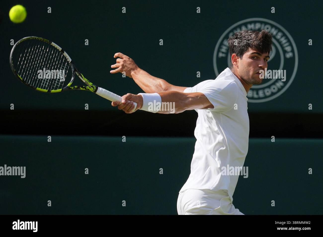 Carlos Alcaraz of Spain returns to Italy's Jannik Sinner in the men's ...