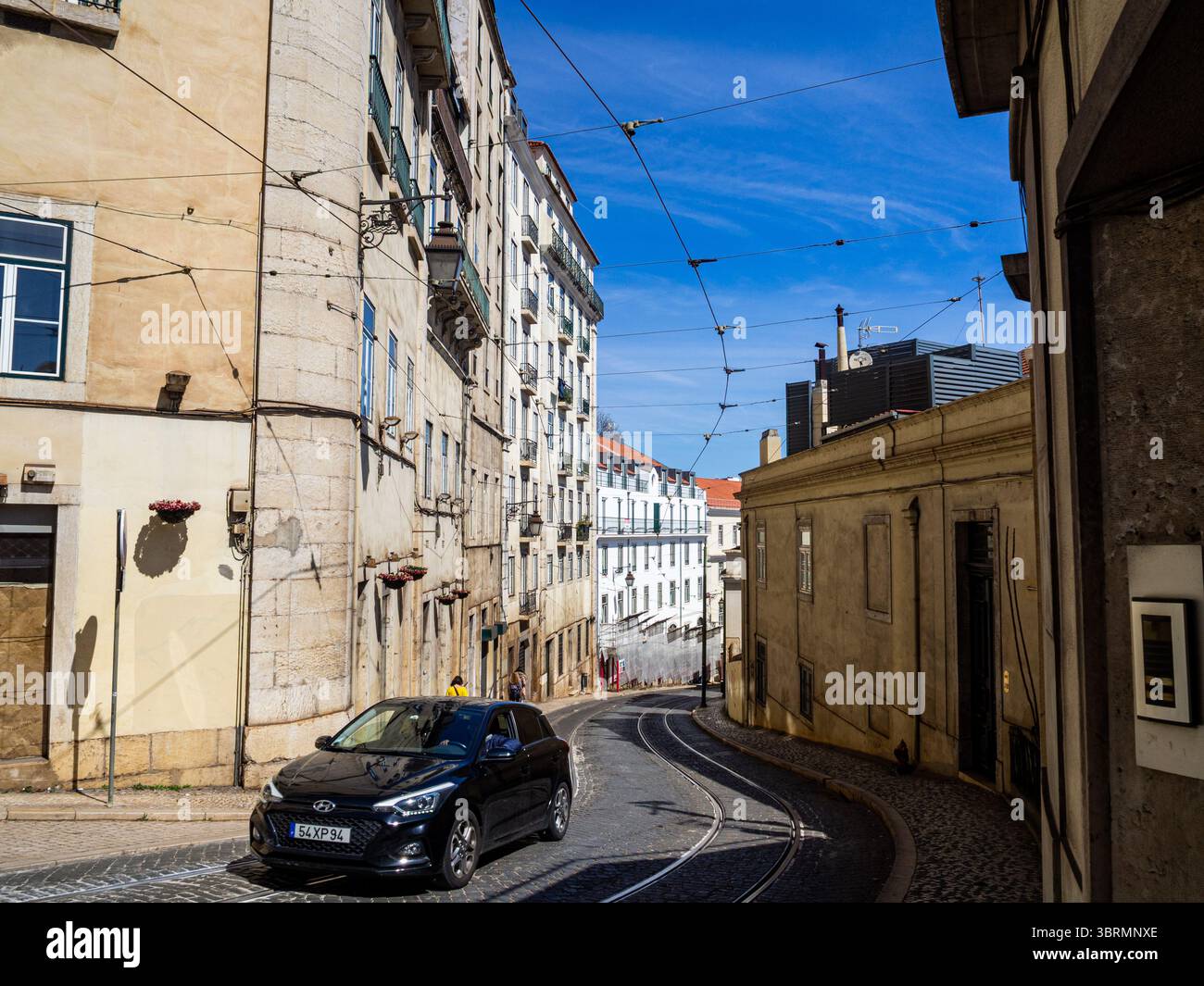 Hilly, curving street in Lisbon, Portugal Stock Photo - Alamy