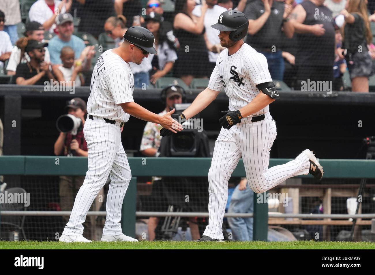Chicago White Sox's Austin Slater, right, celebrates with third base ...