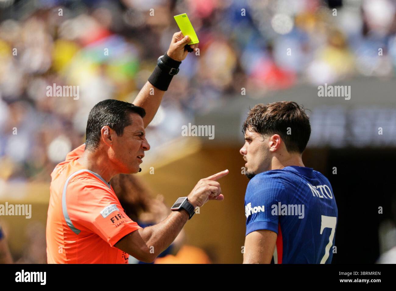 Referee Alireza Faghani shows the yellow card to Chelsea's Pedro Neto ...