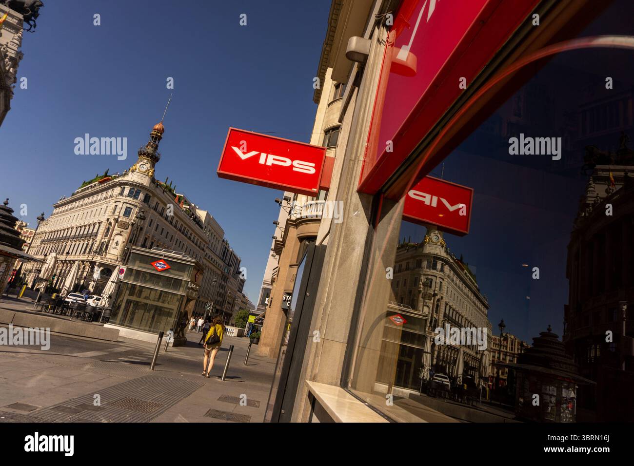 The facade of the Four Seasons Hotel Madrid is reflected in the window ...