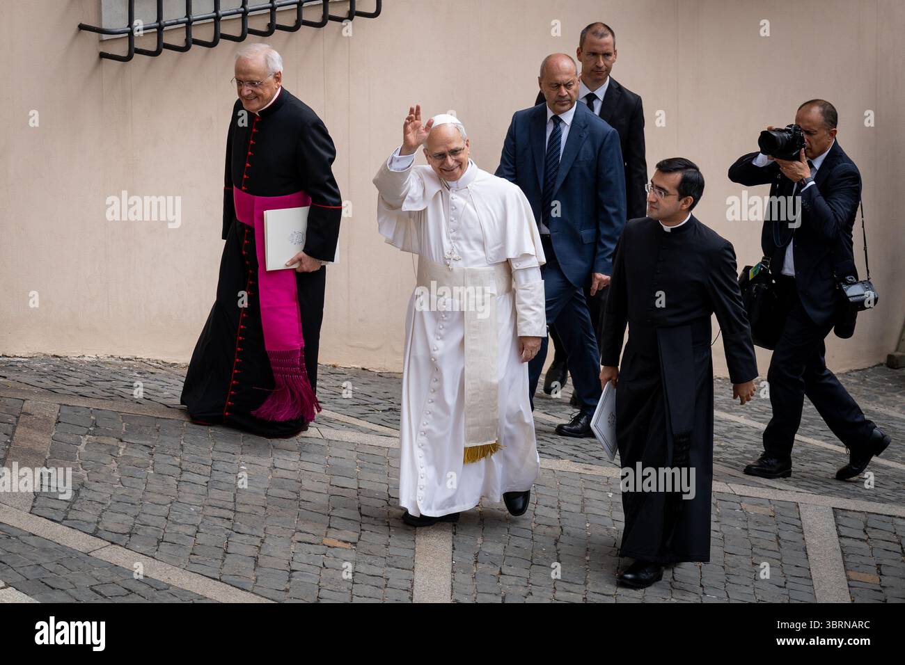 Pope Leo XIV greets the faithful after the traditional Sunday Angelus ...
