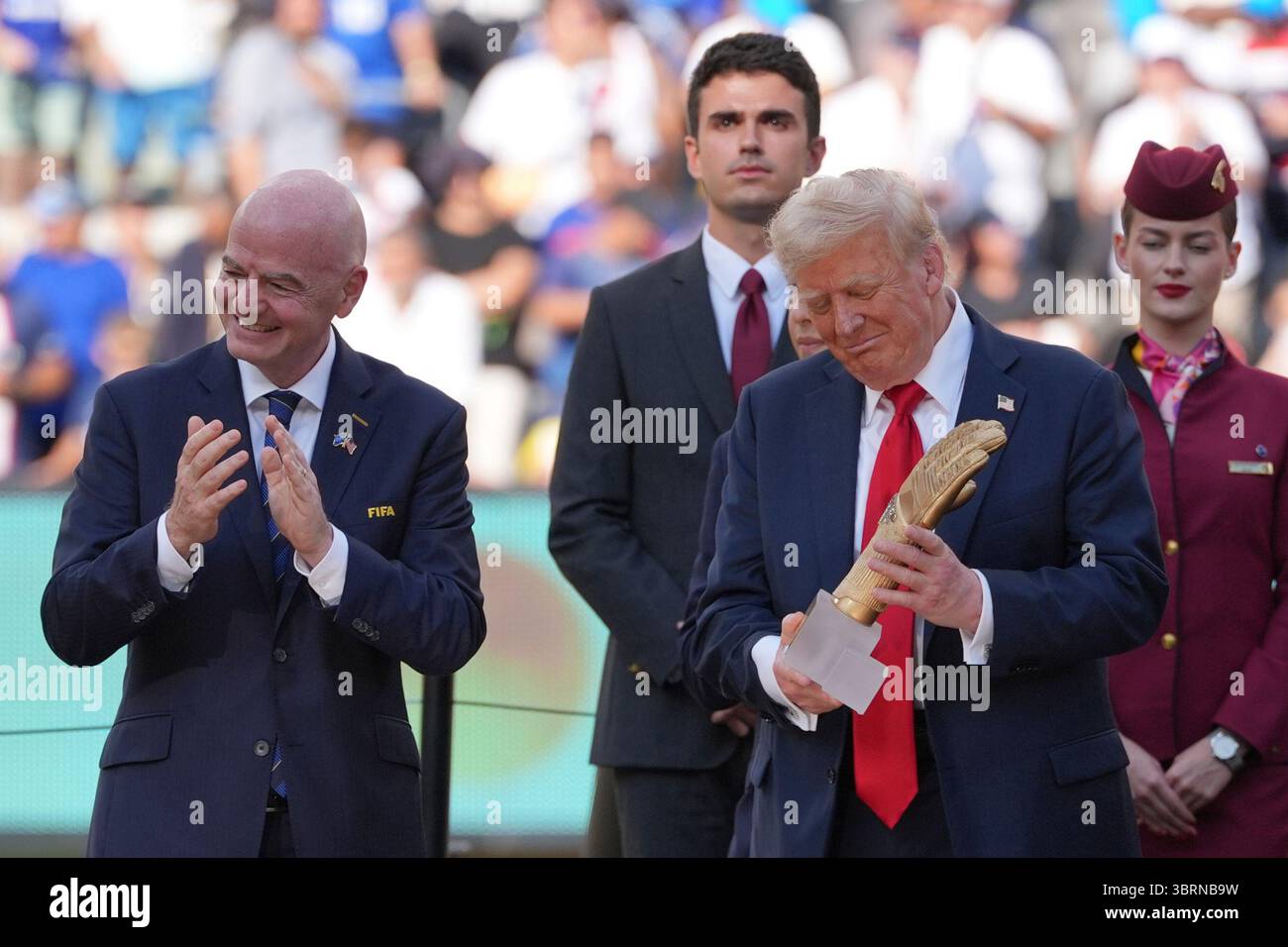 President Donald Trump looks at the best goalkeeper award along side ...