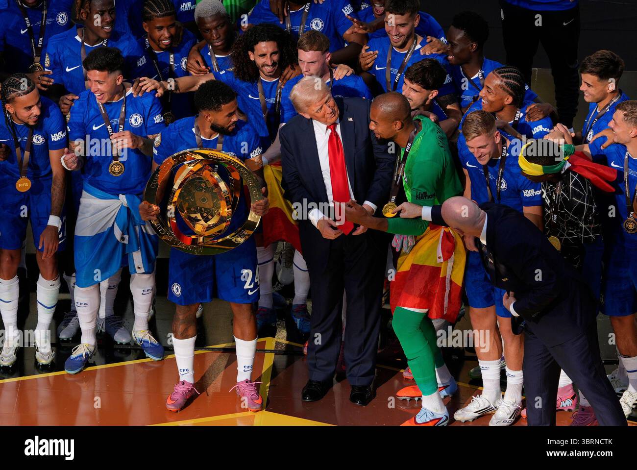 Chelsea's Reece James holds the trophy besides President Donald Trump ...