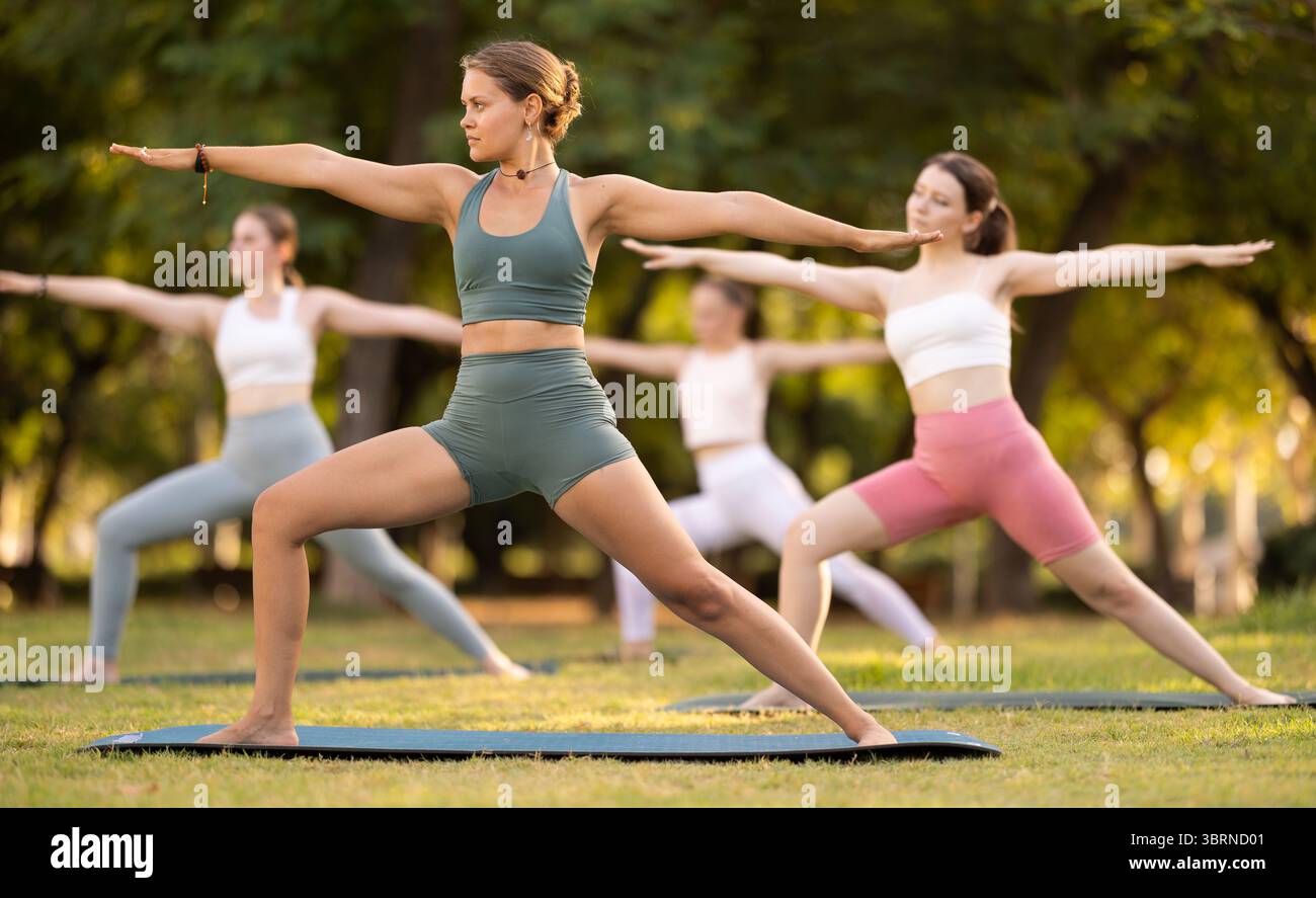 Happy women standing yoga pose and making full body stretching workout ...