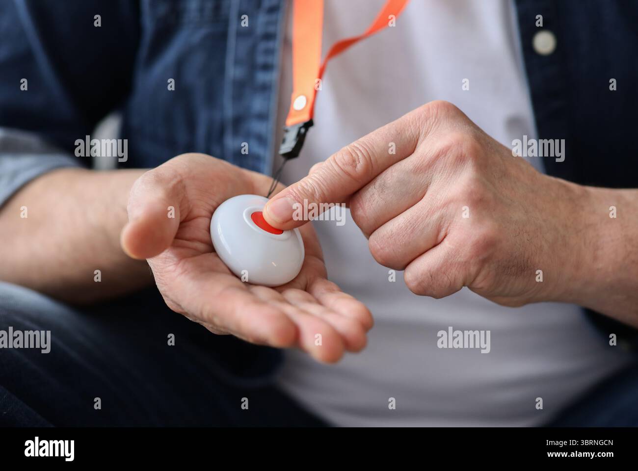 Hand pushing panic button on emergency equipment for elderly people ...