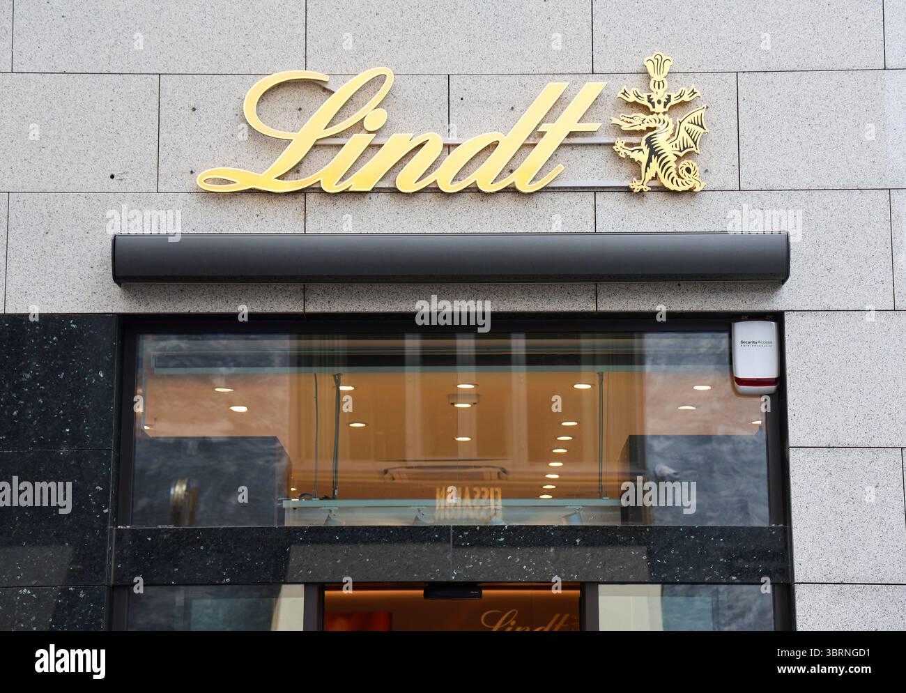Vienna, Austria - 12. July 2025: Golden Lindt logo with its dragon, on ...