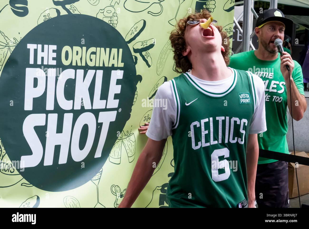 Visitors to the Picklesburgh event attempt to catch a pickle in their ...