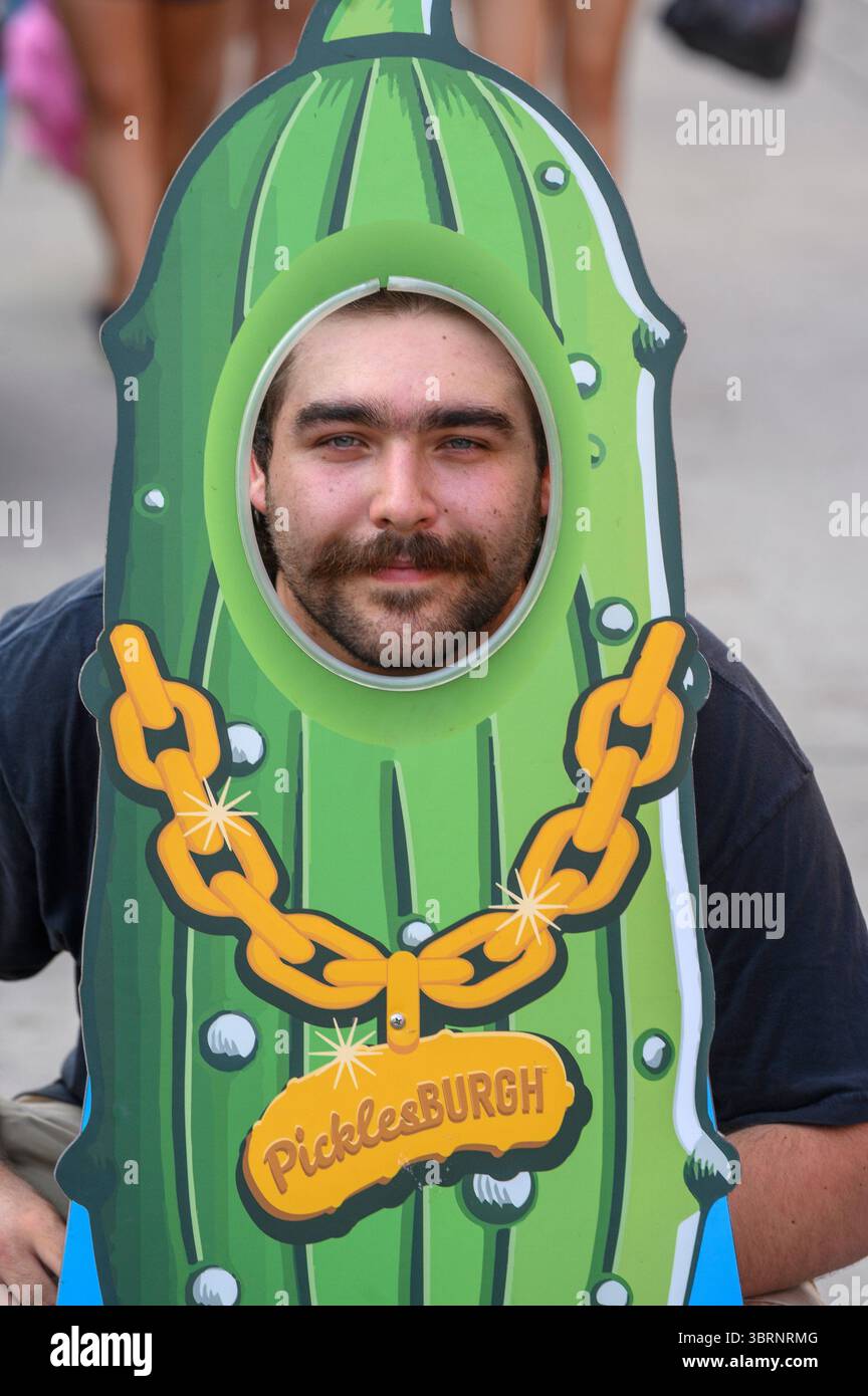 Visitors to the Picklesburgh event pose for photos in cutouts of ...