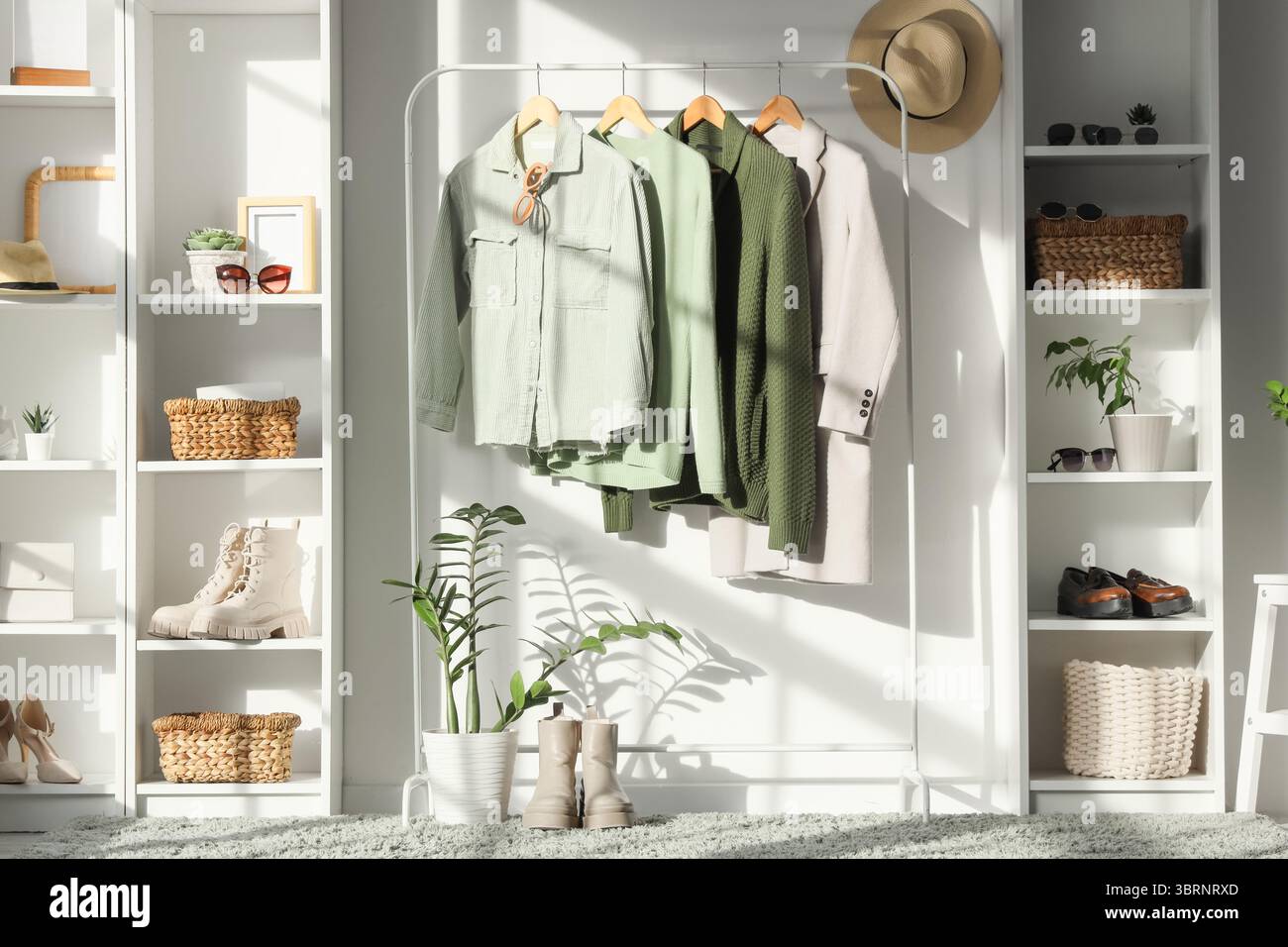 Interior of dressing room with clothes rack and shelf units Stock Photo ...