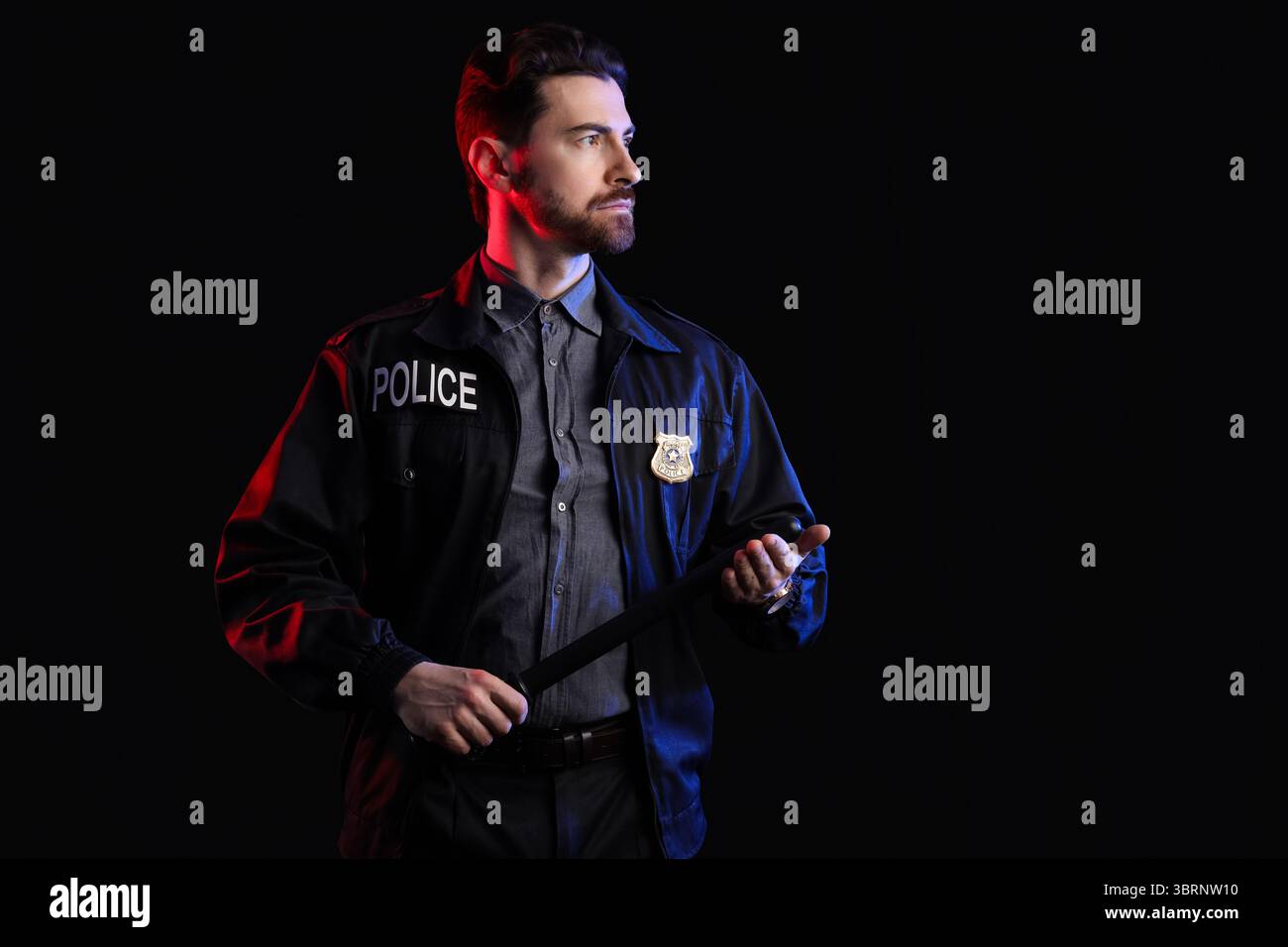Male police officer with baton on black background Stock Photo - Alamy