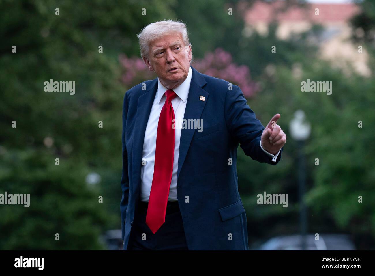 President Donald Trump talks to reporters as he walks on the South Lawn ...