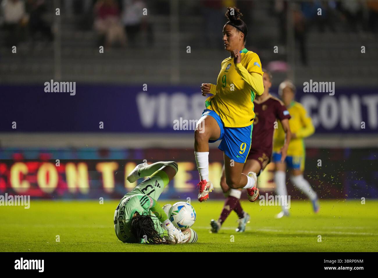 Amanda Gutierres of Brazil jumps over goalkeeper Nayluisa Caceres of ...