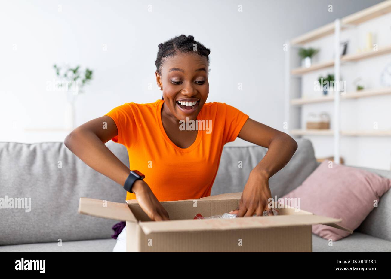 Emotional black female customer receiving long-awaited package, opening ...