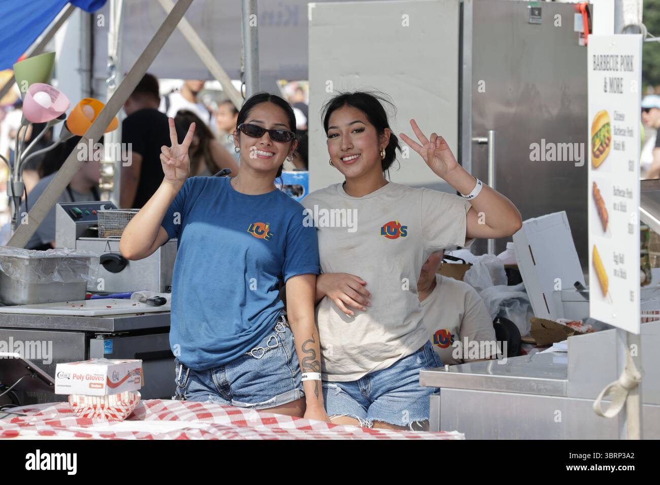 Bloomington, MN, USA. 13th July, 2025. Two young females hold up peace ...