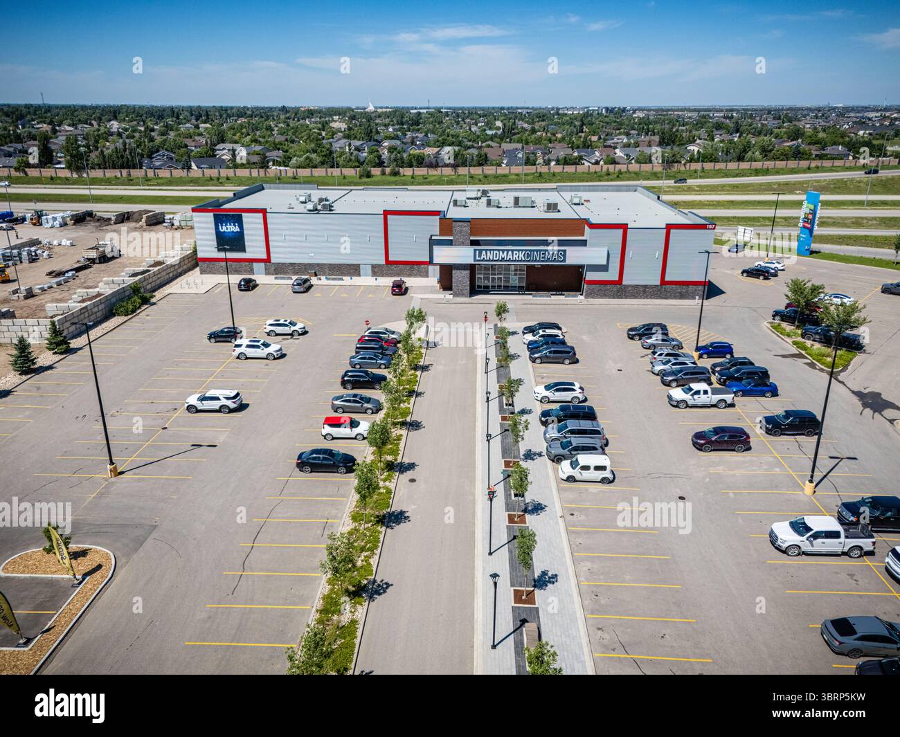 Large parking lot with a building in the background. The parking lot is ...
