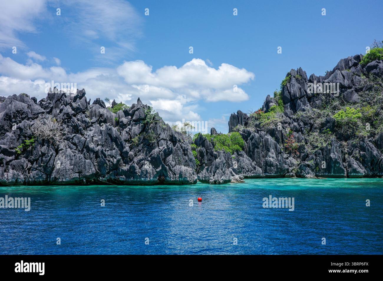 A beautiful view of limestone cliffs, clear blue sky and deep blue ...