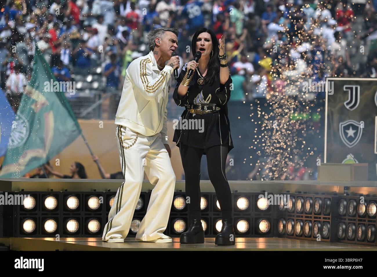 East Rutherford, USA. 13th July, 2025. (L-R) Singers Robbie Williams ...