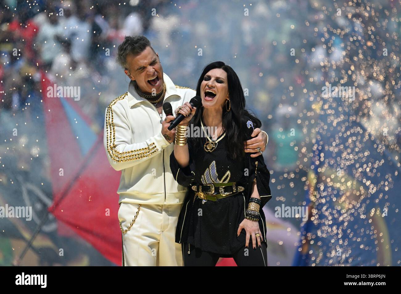 East Rutherford, USA. 13th July, 2025. (L-R) Singers Robbie Williams ...