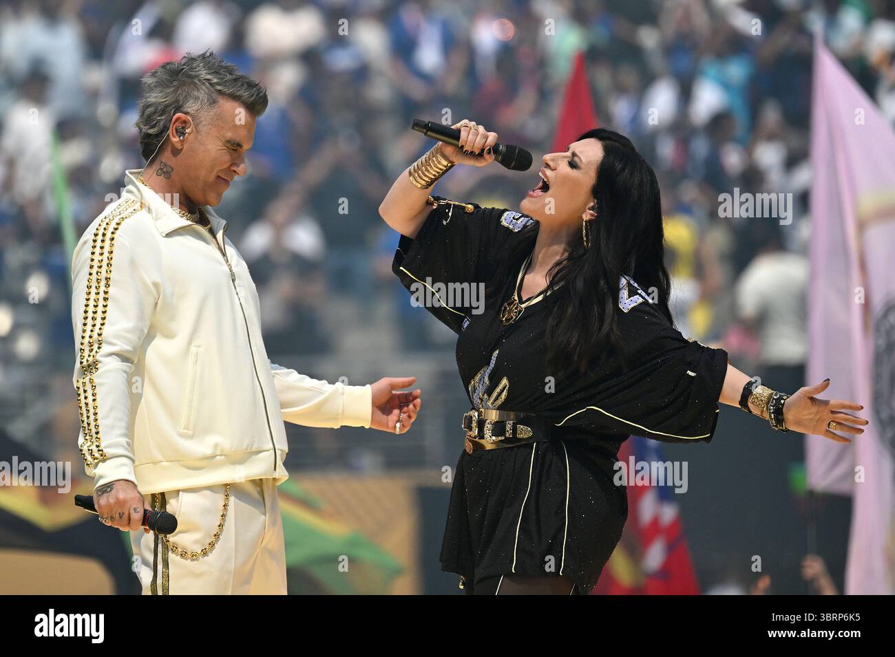 East Rutherford, USA. 13th July, 2025. (L-R) Singers Robbie Williams ...
