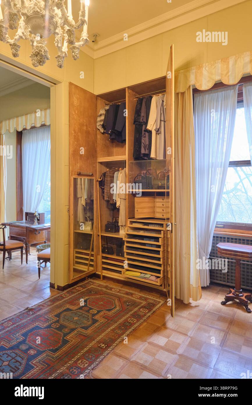 One of the wardrobes, closets, full of clothes, in a bedroom. At the ...