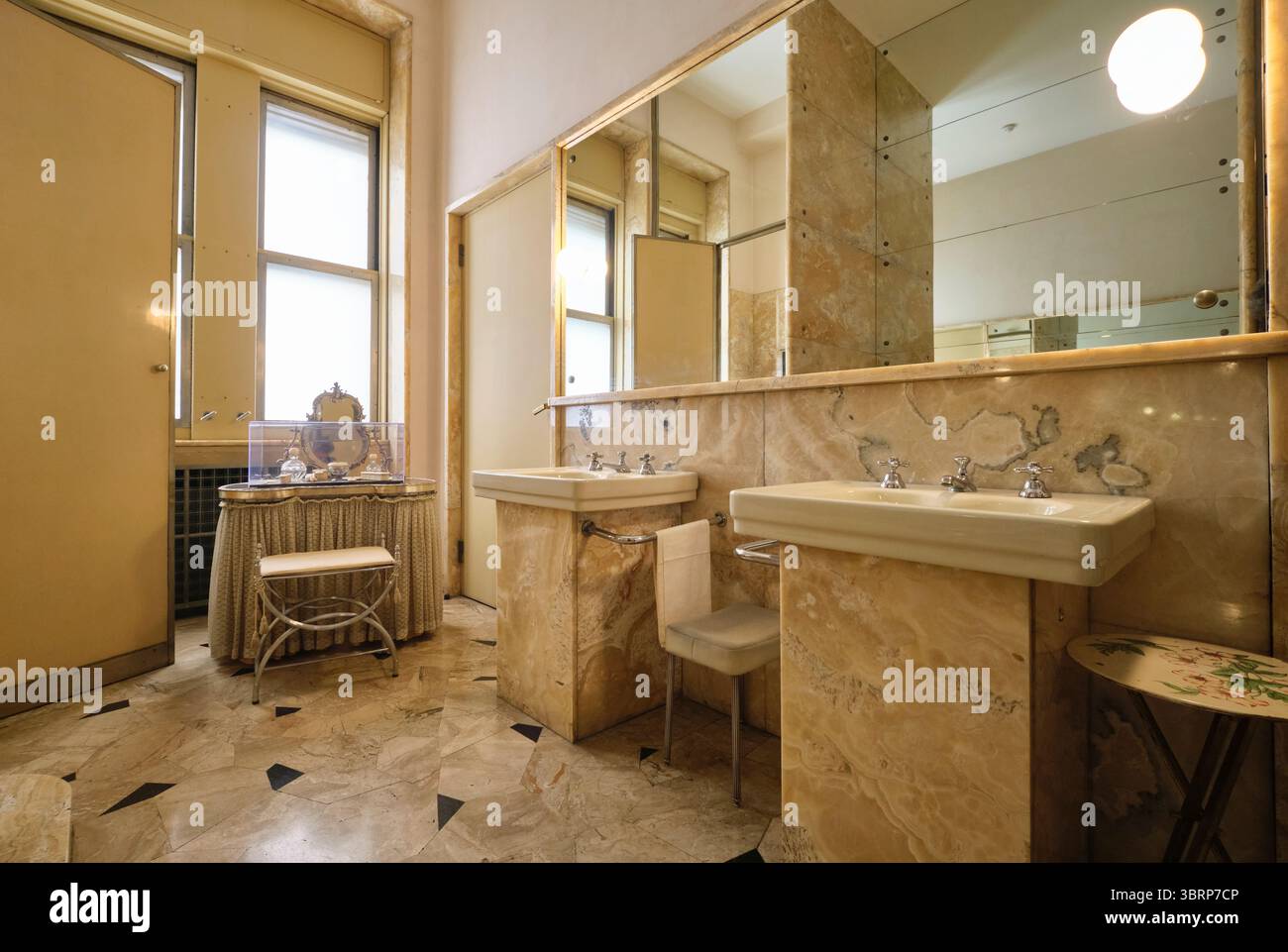 Double sinks in a large, marble bathroom. At the Italian Rationalism ...