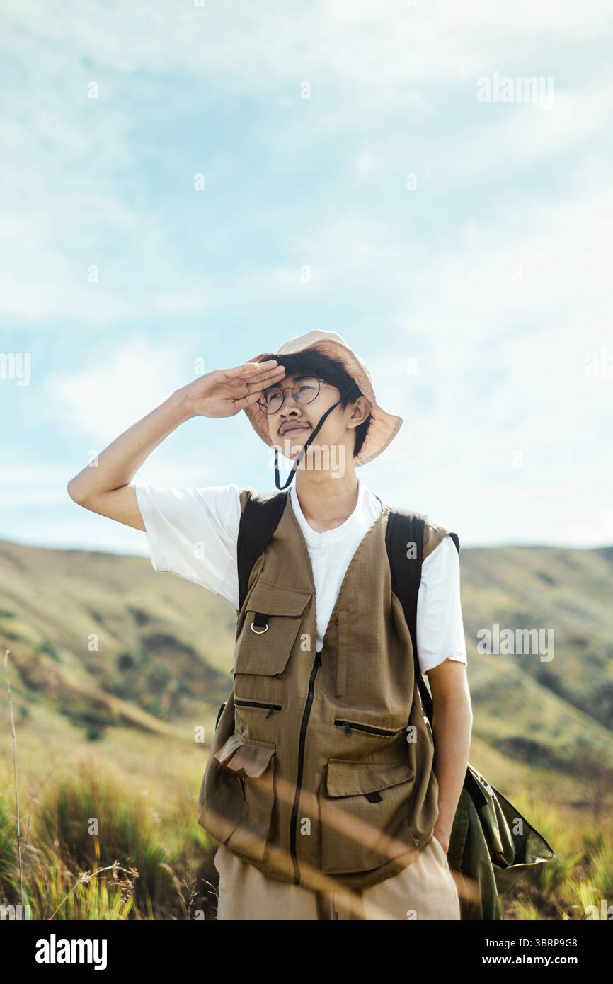 Smiling Southeast Asian man wearing bucket hat, glasses, white t-shirt ...