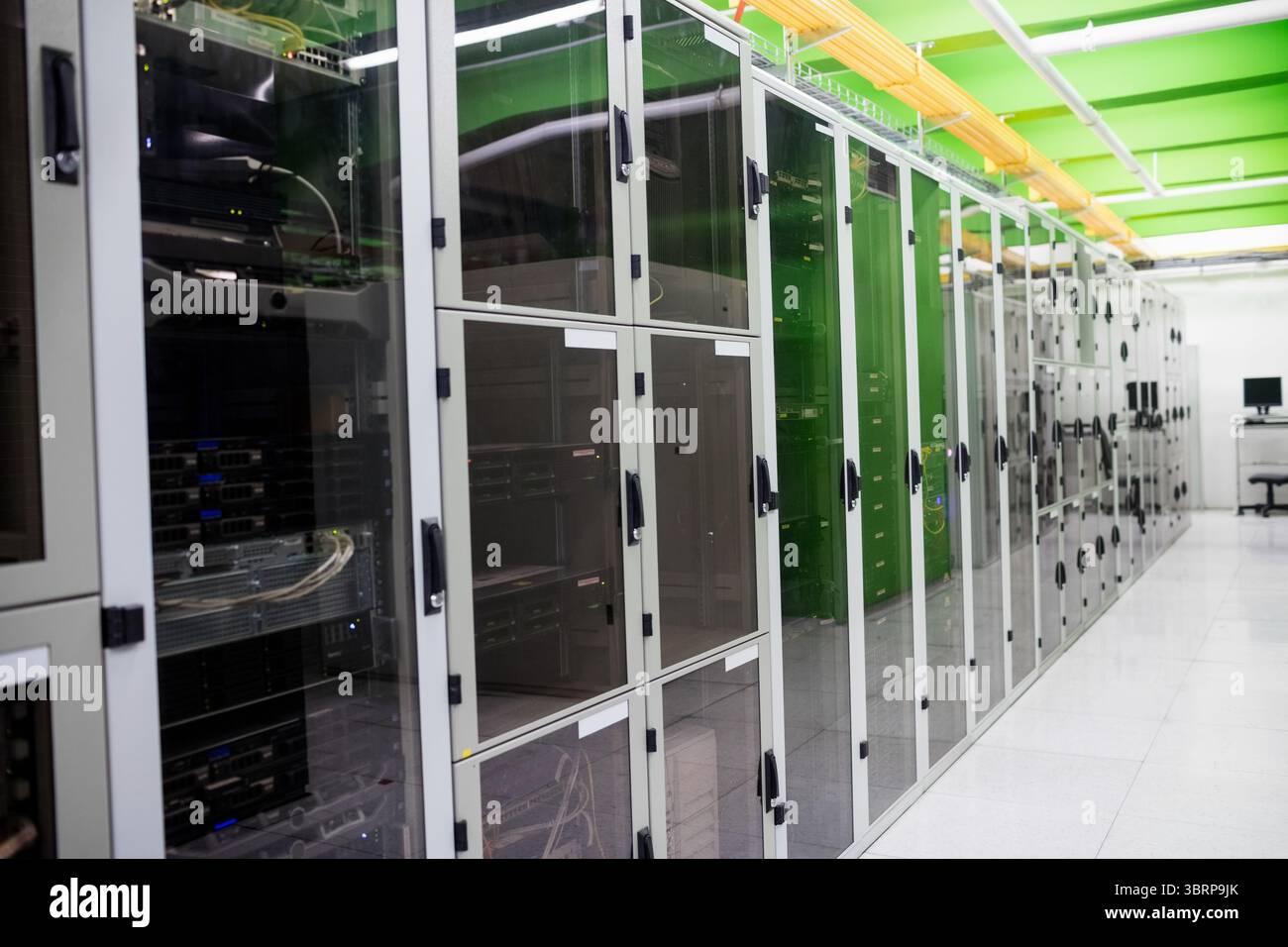 Long row of server cabinets is stretching along data center corridor in ...