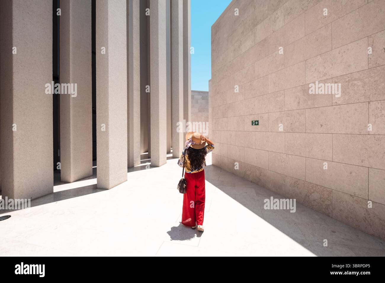 Woman exploring Contemporary Museum Architecture, Modern Pillars and ...