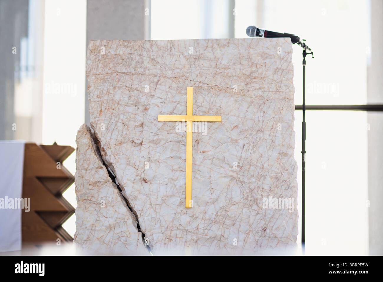 Modern Catholic church interior featuring a marble altar with a yellow ...