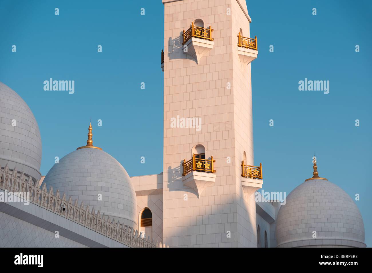 grand mosque minaret close-up at sunset, golden light on mosque dome ...
