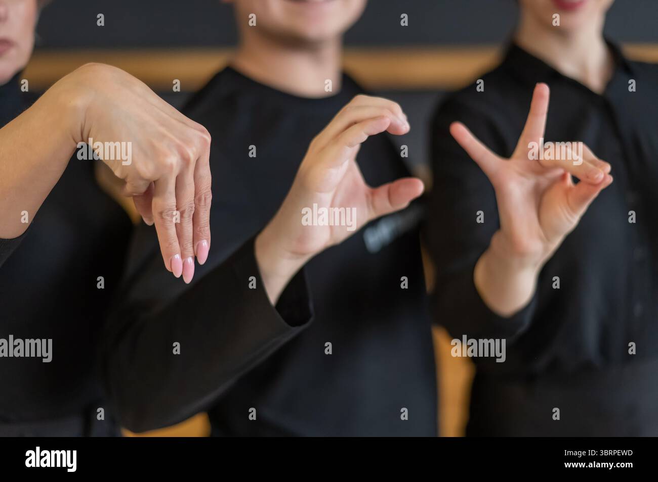 A man and two women demonstrate a phrase in sign language Stock Photo ...