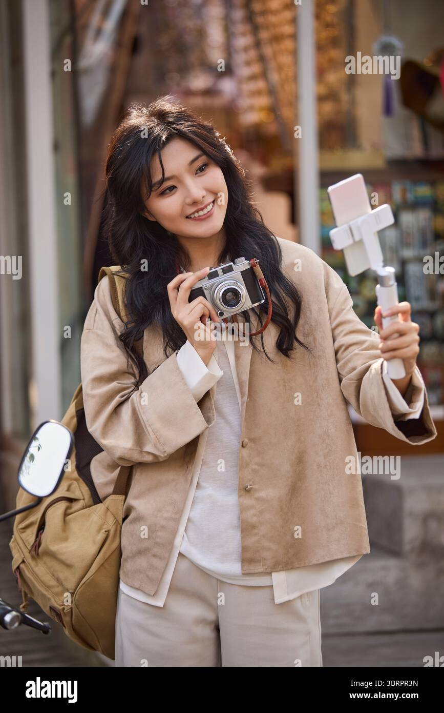 Happy female influencer webcasts while traveling Stock Photo - Alamy