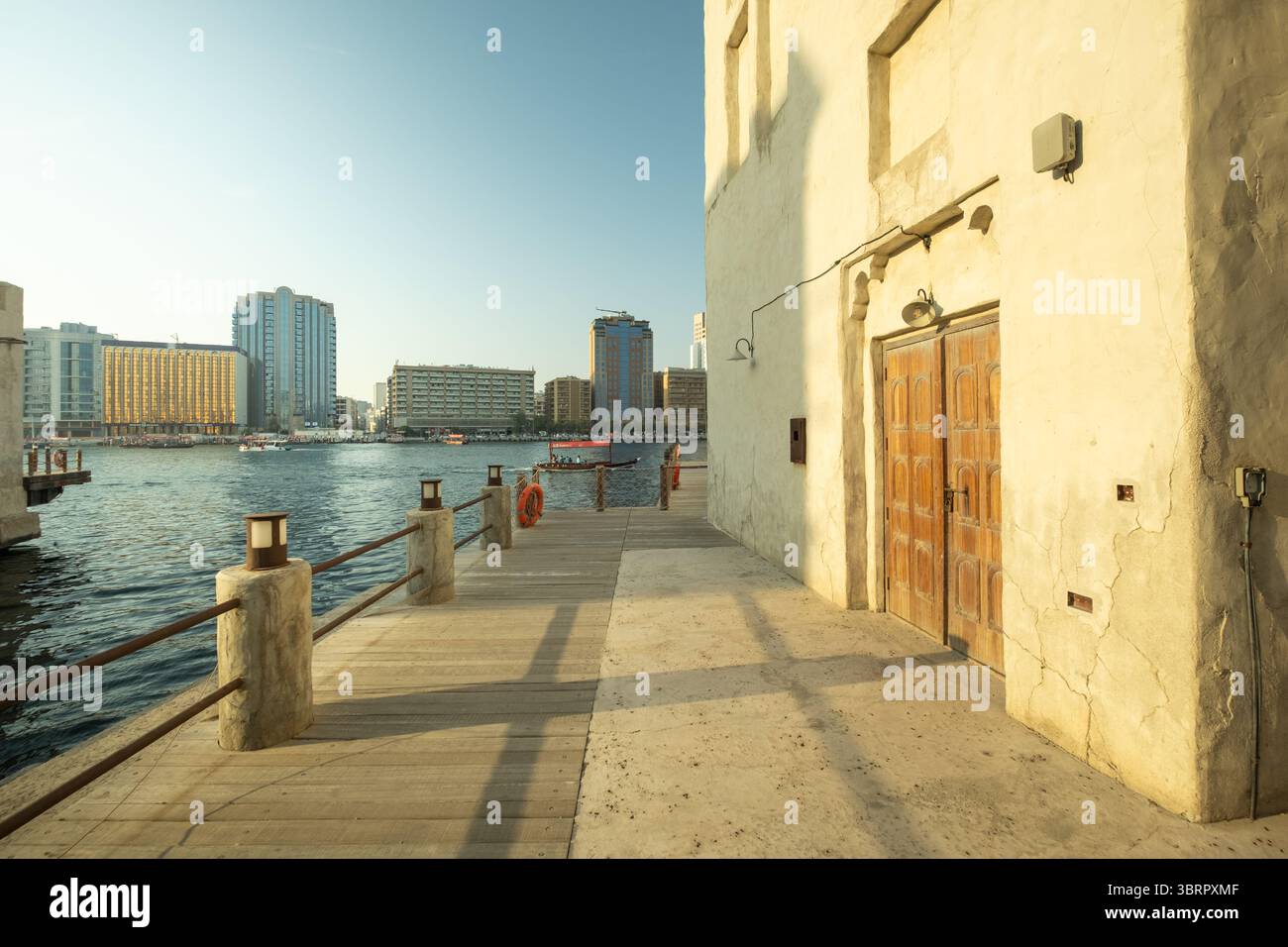 Waterfront view of Dubai creek from Al seef heritage park at sunset ...