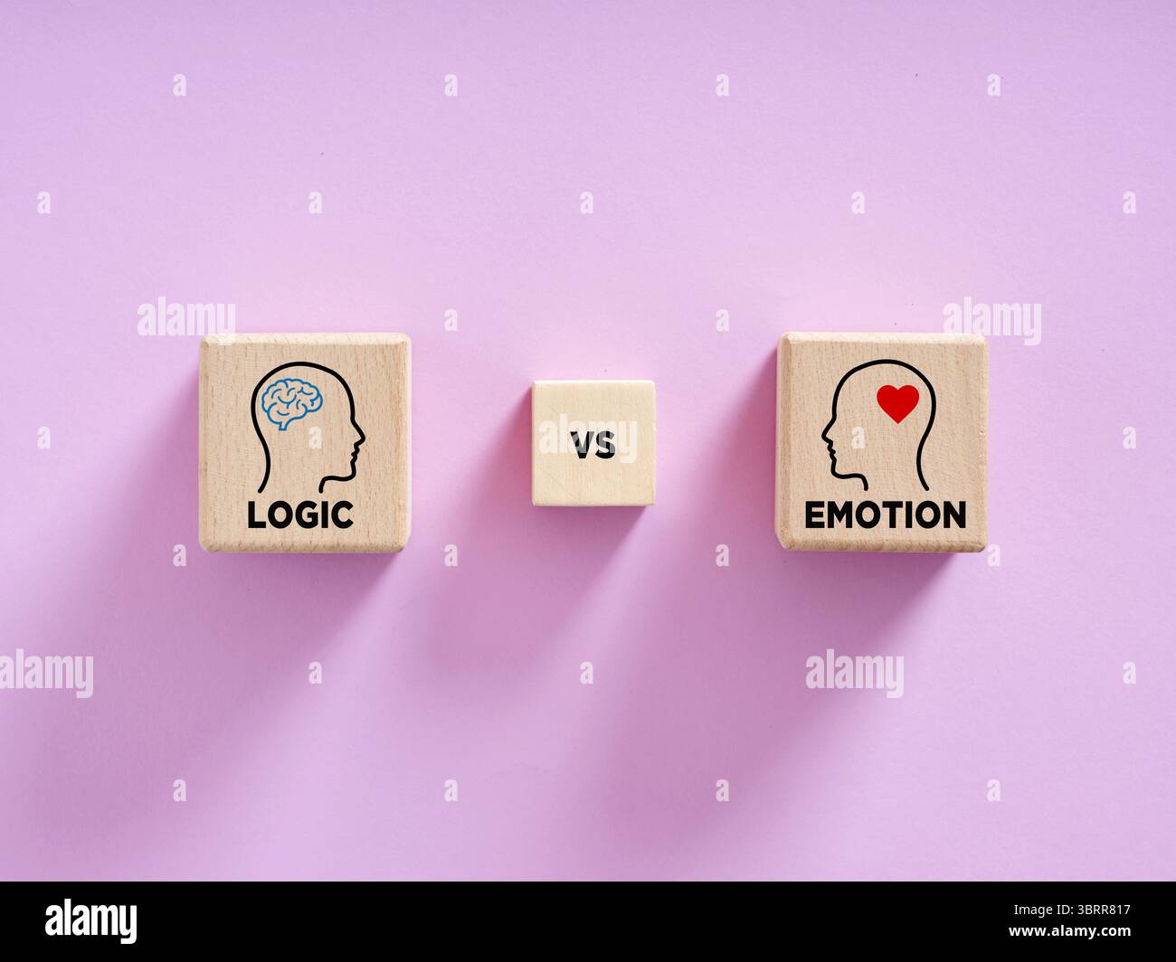 Wooden blocks representing logic and emotion facing each other ...