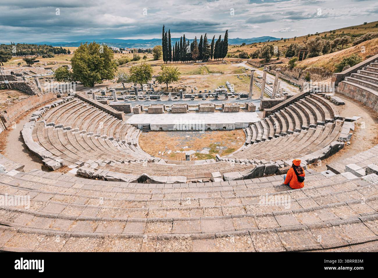 Tourist admiring the ancient Asklepion Theatre in Pergamon, Turkey, a ...