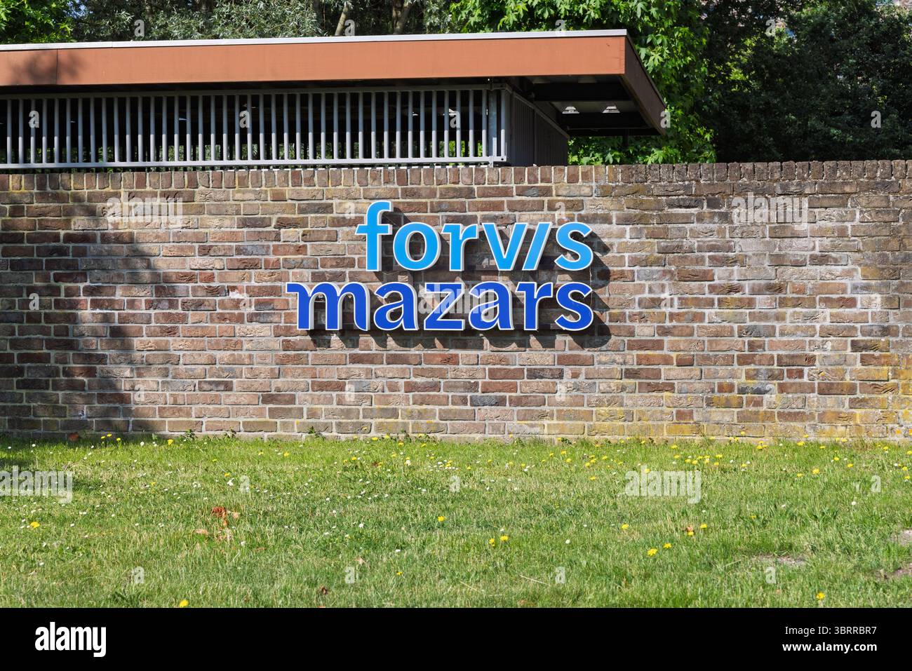 A prominent "forvis mazars" sign in blue lettering affixed to a classic ...