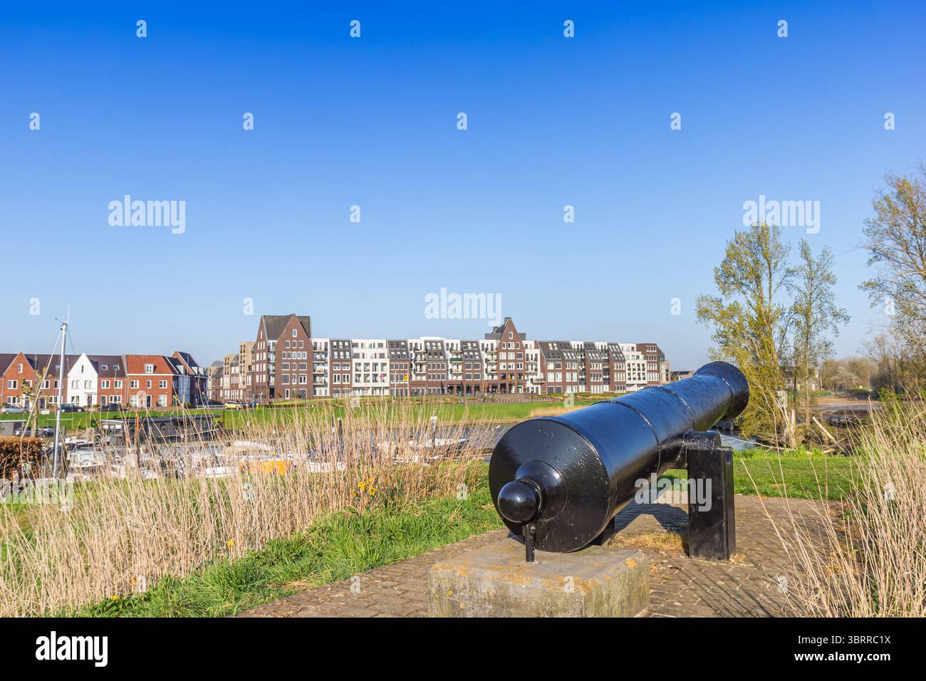 Historic cannon on top of the dike in Grave, Netherlands Stock Photo ...