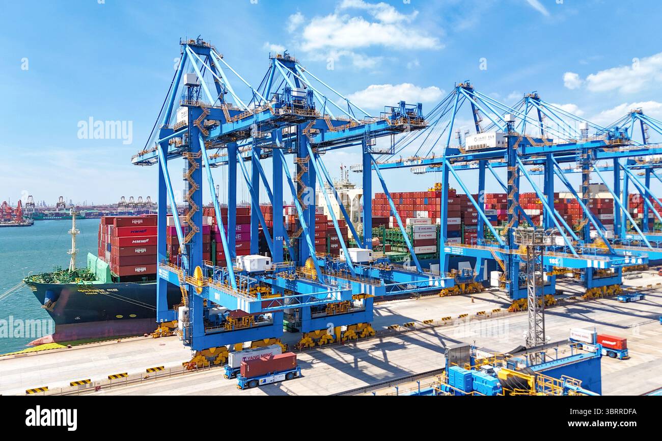 Several container ships are loading and unloading goods at the fully automated terminal of ...